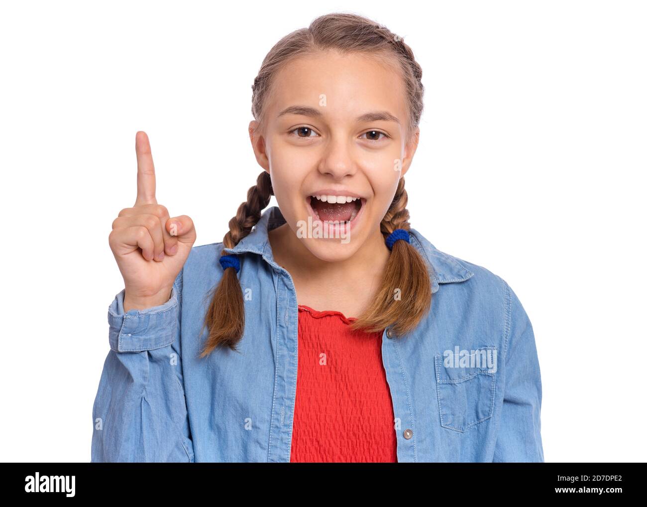 Happy teenage girl pointing up, gesturing idea or doing number one ...