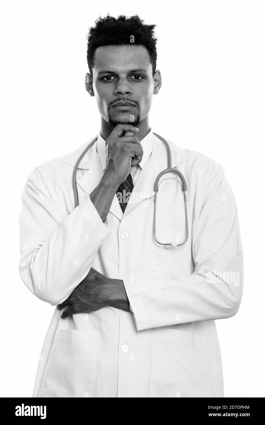 Studio shot of young African man doctor thinking Stock Photo - Alamy