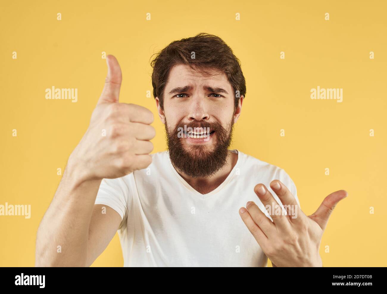 Man shows positive hand gesture emotions fun yellow background Stock Photo - Alamy