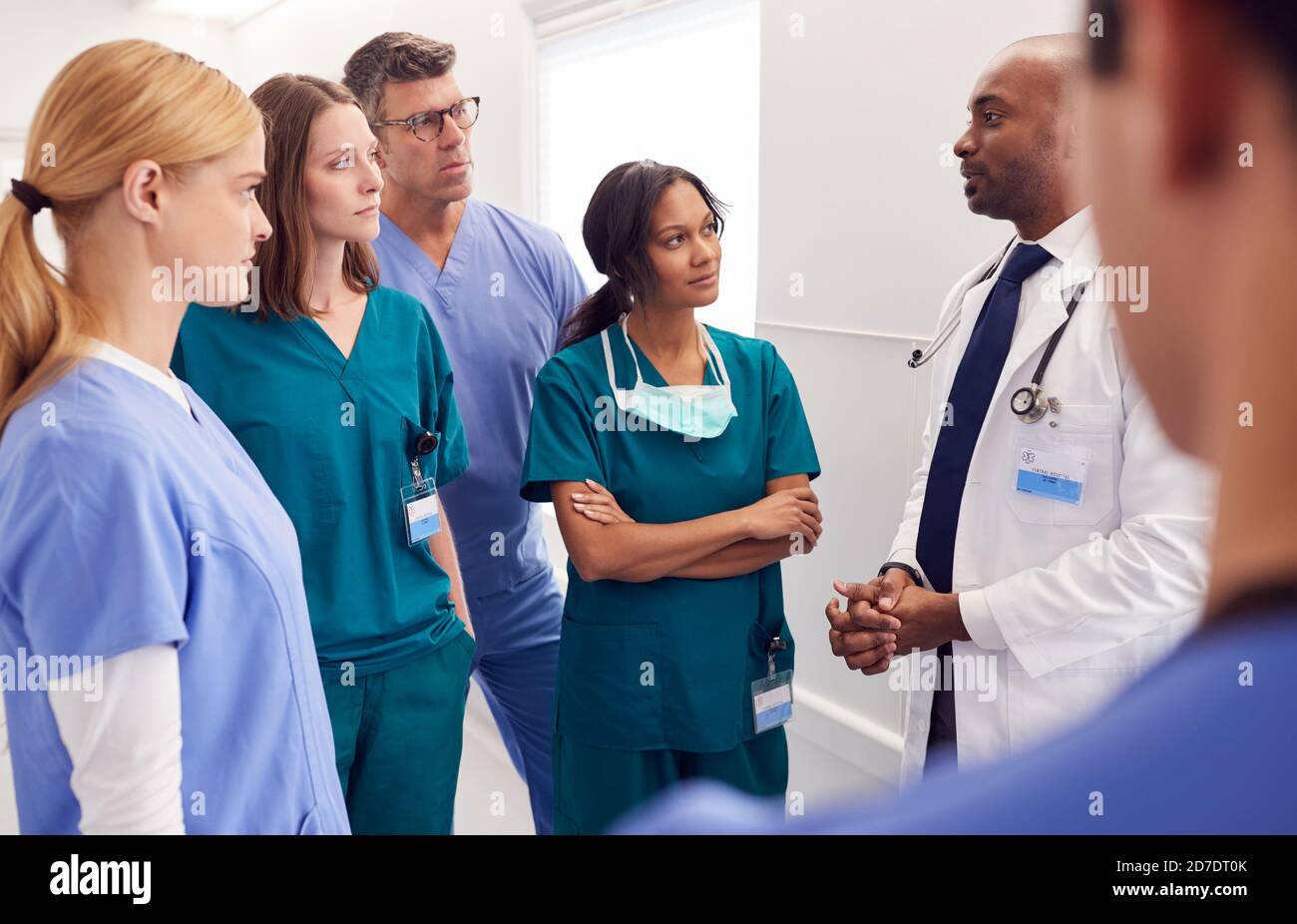 Multi-Cultural Medical Team Having Meeting In Hospital Corridor Stock Photo - Alamy