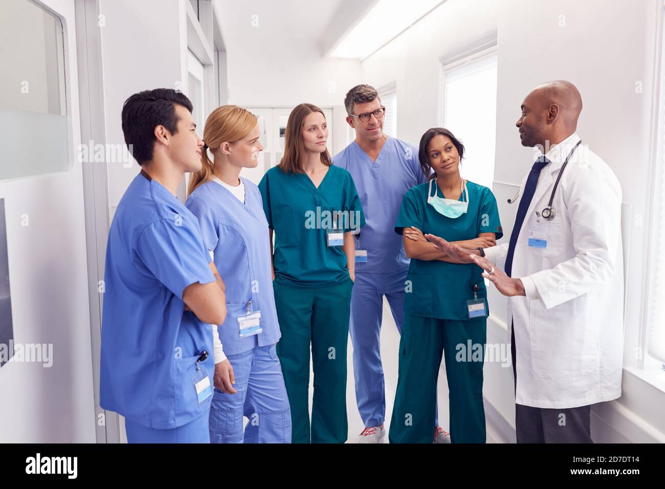 Multi-Cultural Medical Team Having Meeting In Hospital Corridor Stock Photo - Alamy