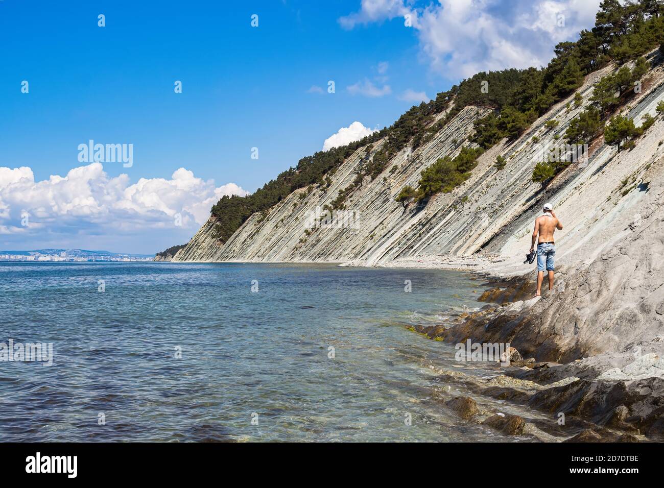 Walk along the wild stone beach at the foot of the cliffs. Beautiful ...