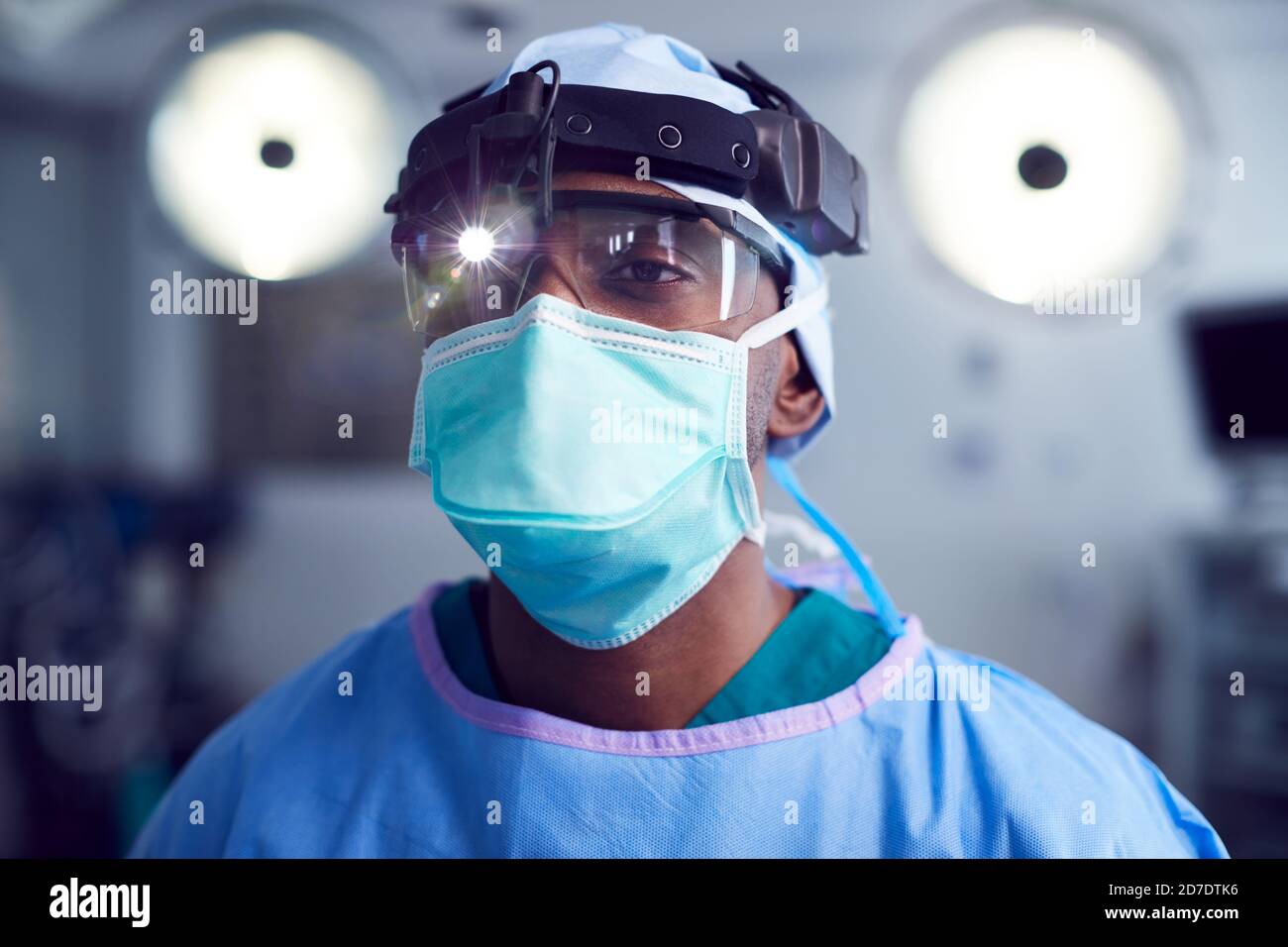 Portrait Of Male Surgeon Wearing Protective Glasses And Head Light In ...