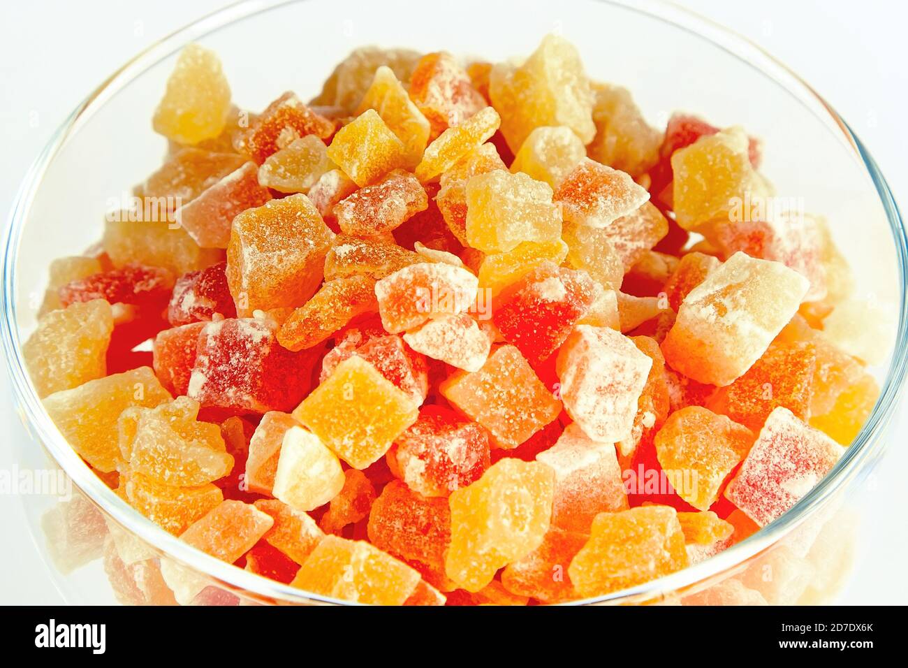 Close-up orange and yellow color pieces of dry tropical fruits in glass ...