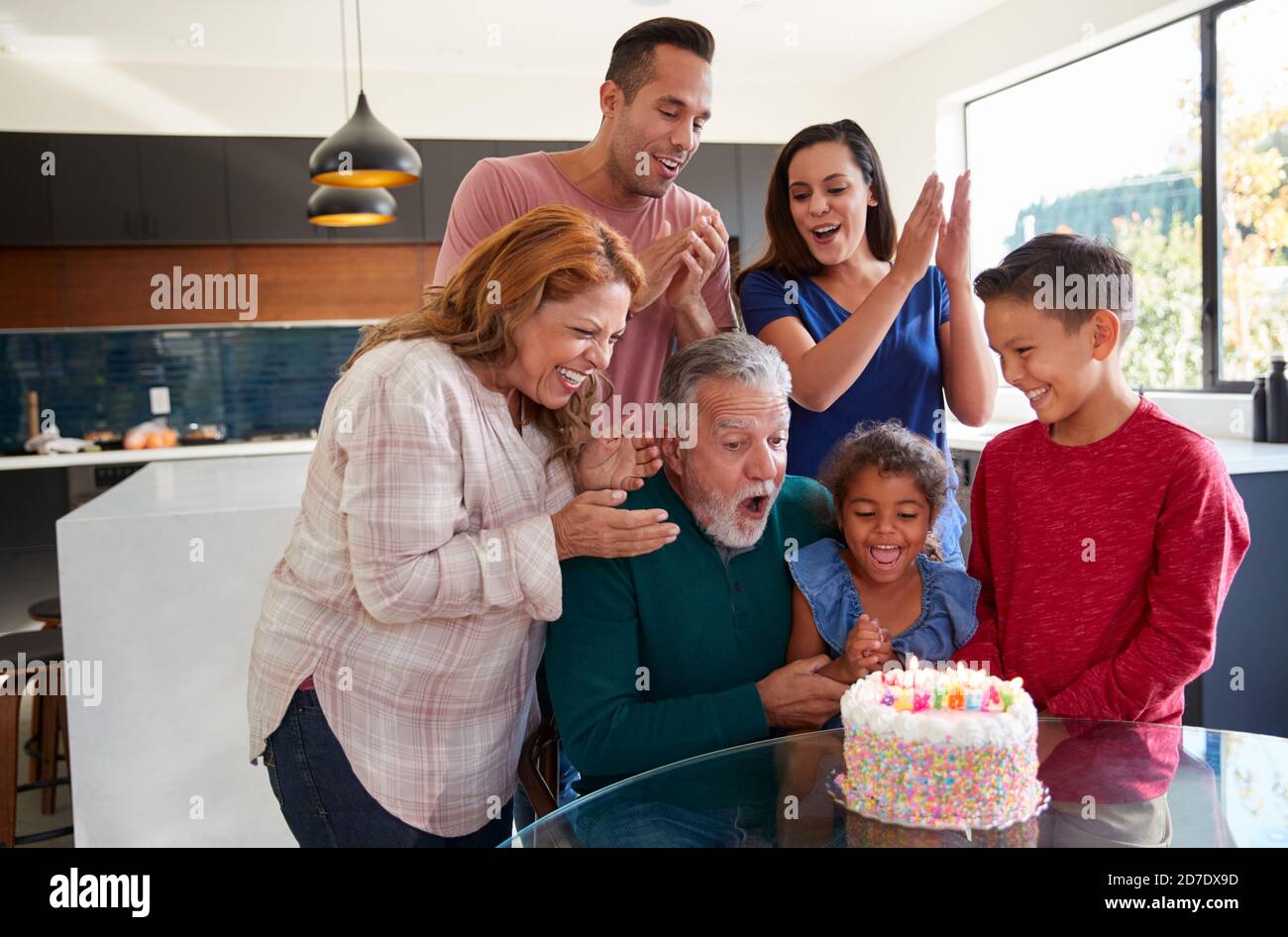 Multi-Generation Hispanic Family Celebrating Granddaughters Birthday At ...