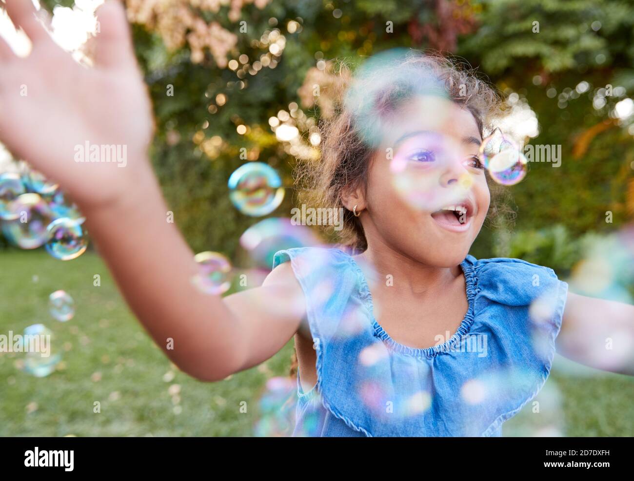 Girl catching bubbles hi-res stock photography and images - Alamy