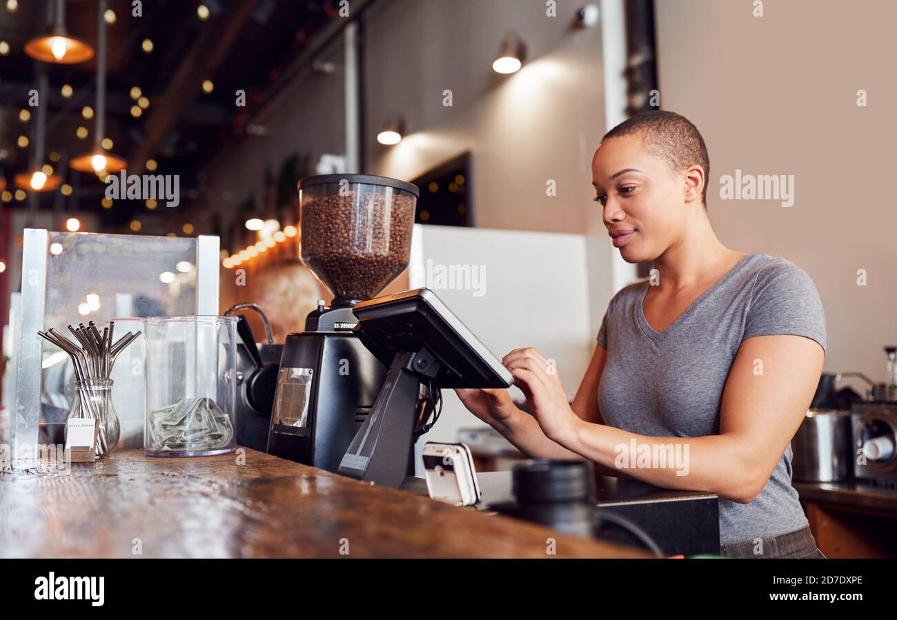Female Coffee Shop Owner Working Behind Sales Desk Stock Photo - Alamy