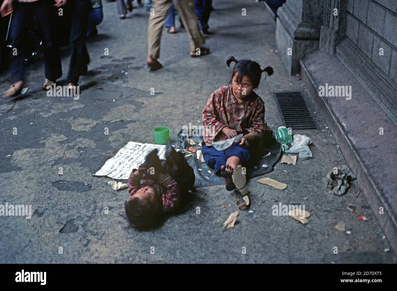 Begging child with eye disability and baby destitute in Chinese street ...