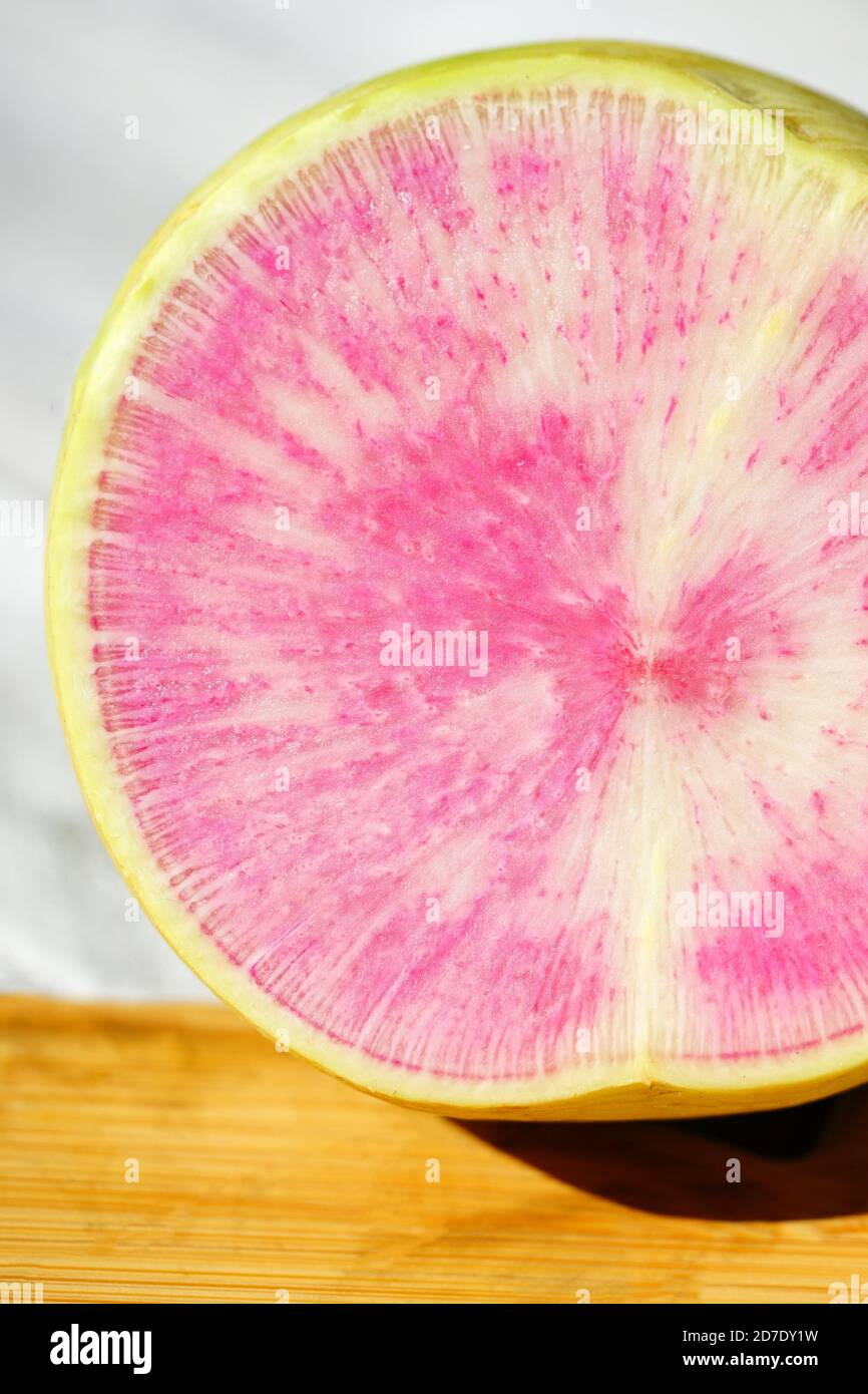 Green and pink watermelon radish cut in half Stock Photo - Alamy