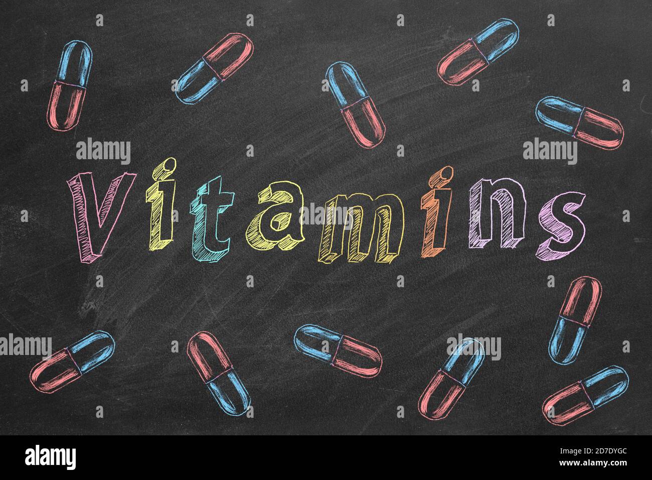 Hand drawing text "Vitamins" and pills on blackboard Stock Photo - Alamy
