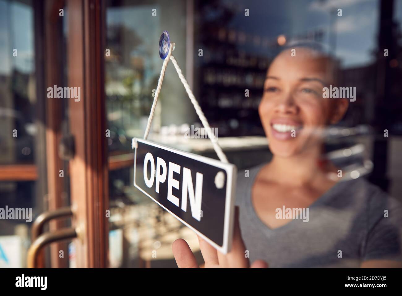 Female Owner Of Start Up Coffee Shop Or Restaurant Turning Round Open ...