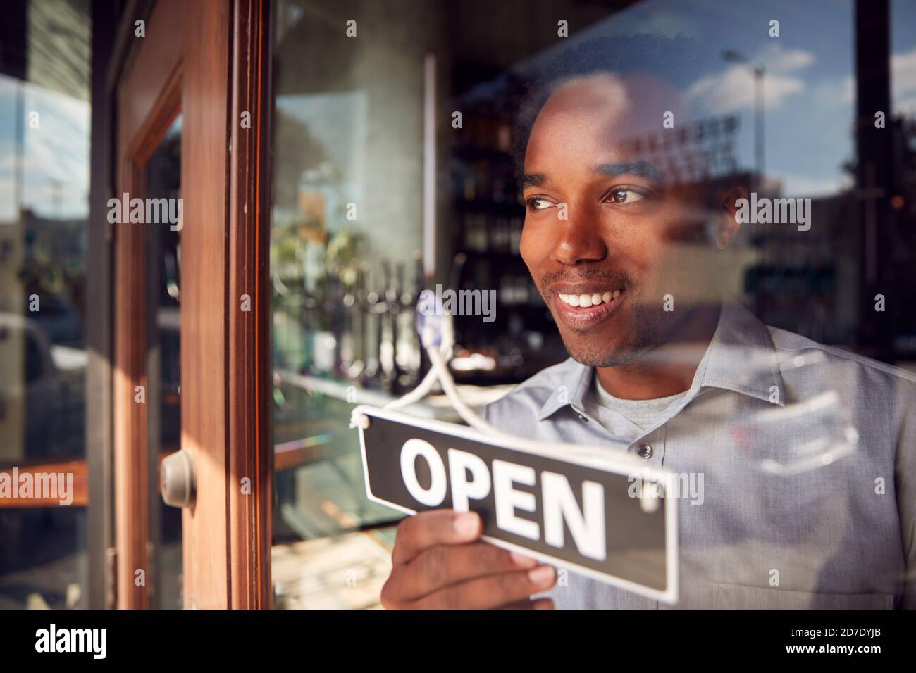 Male Owner Of Start Up Coffee Shop Or Restaurant Turning Round Open ...