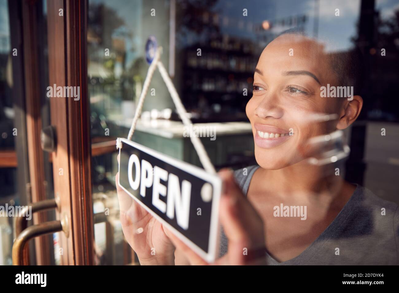 Female Owner Of Start Up Coffee Shop Or Restaurant Turning Round Open ...