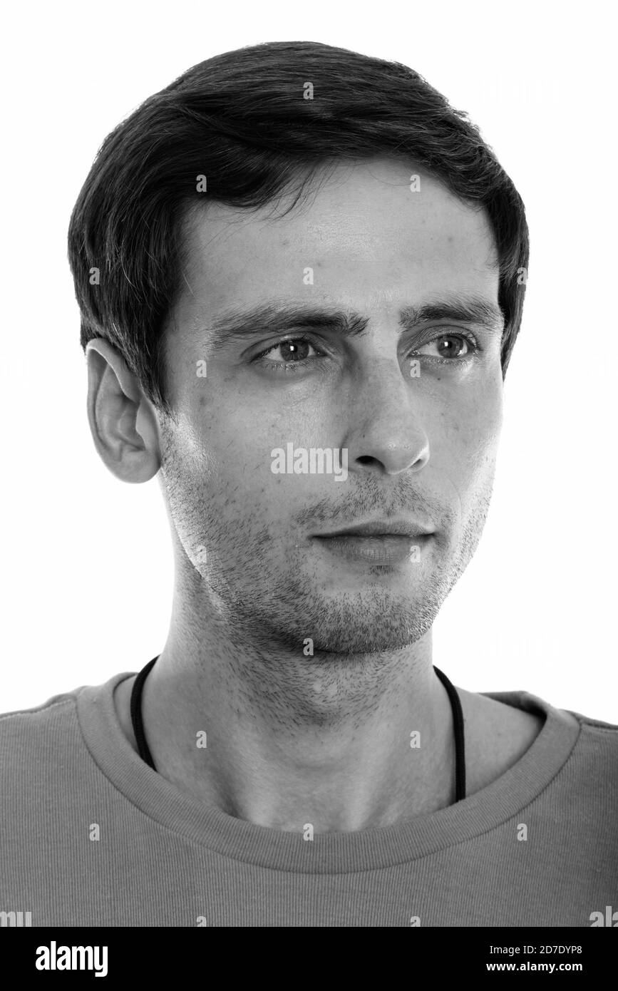 Face of young handsome man thinking while looking at distance Stock ...