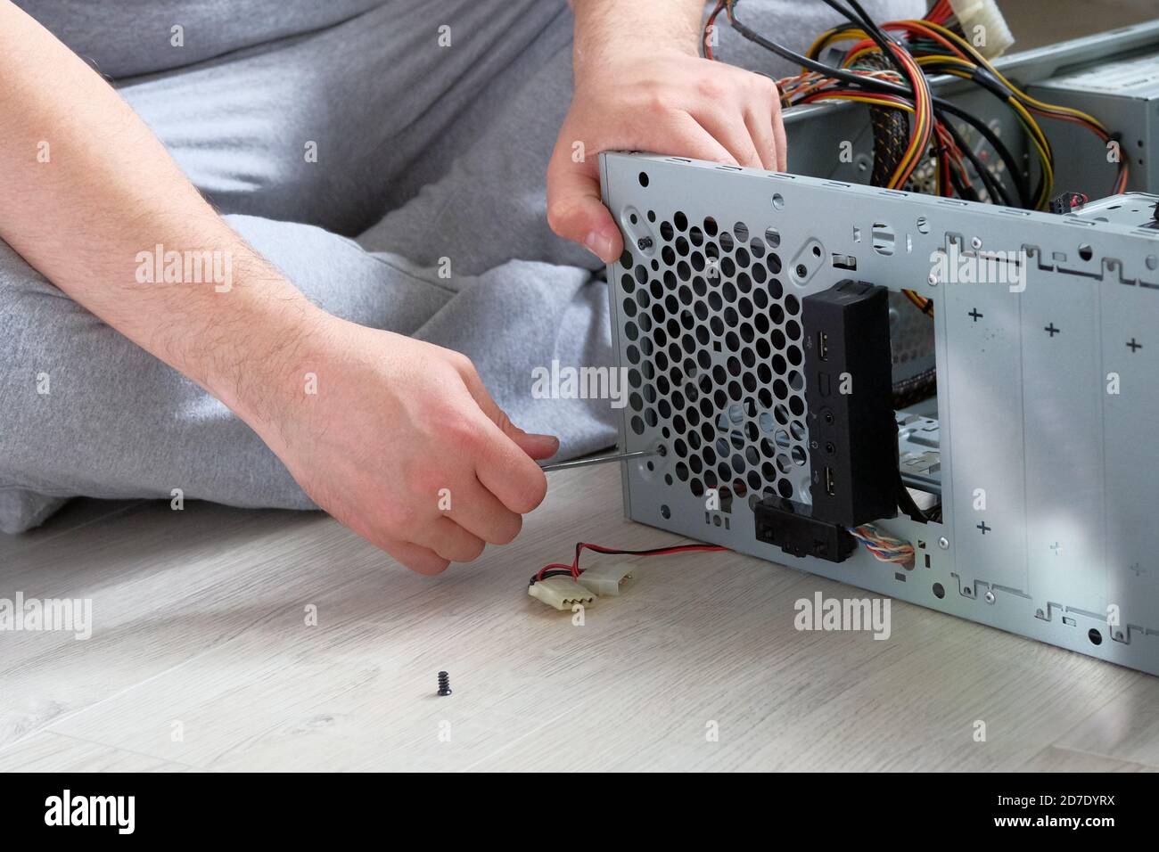 Computer technician repair. Repairman is fixing computer using tools in ...