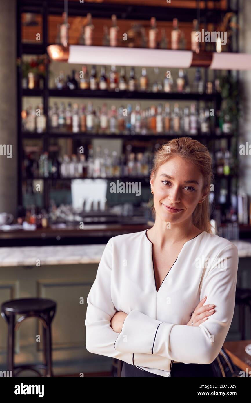 Portrait Of Confident Female Owner Of Restaurant Bar Standing By ...