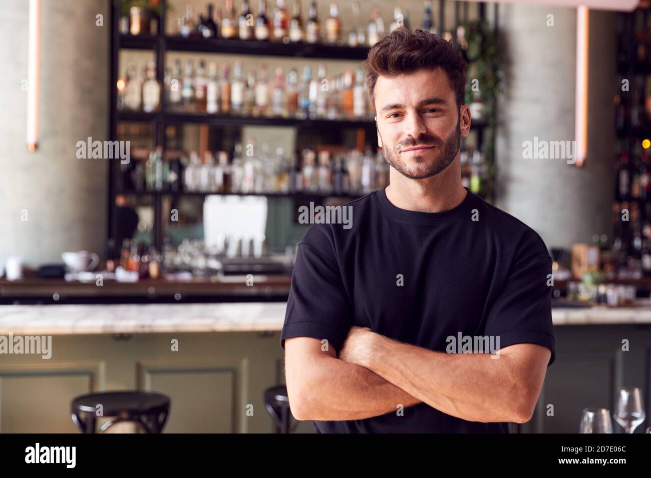 Portrait Of Confident Male Owner Of Restaurant Bar Standing By Counter ...