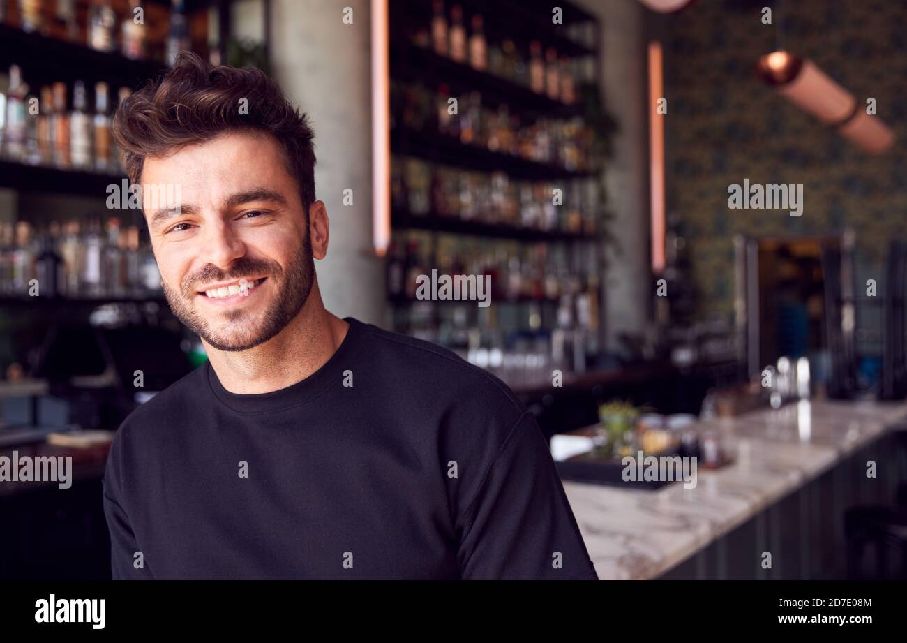 Portrait Of Confident Male Owner Of Restaurant Bar Standing By Counter ...