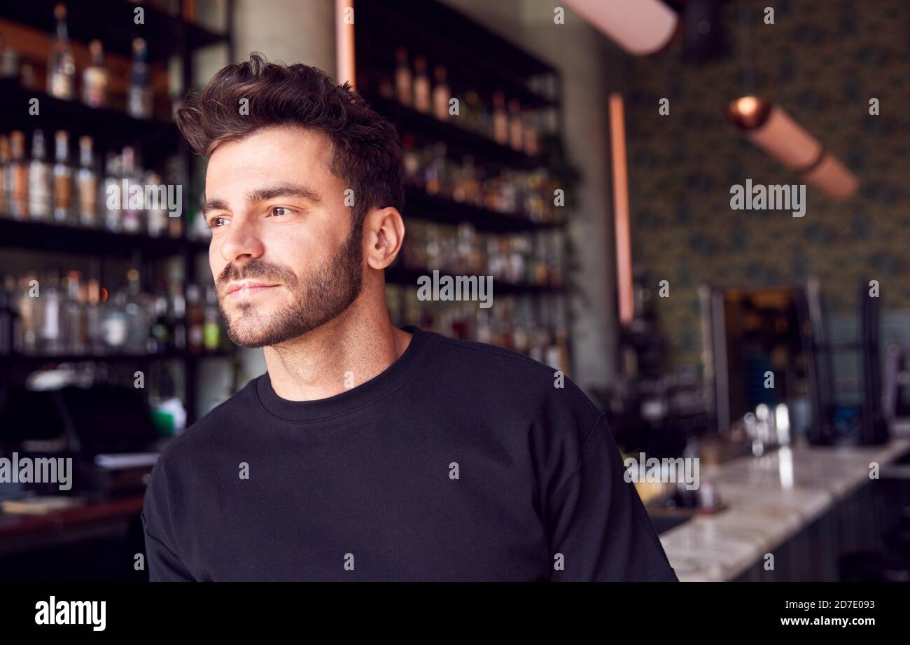 Portrait Of Confident Male Owner Of Restaurant Bar Standing By Counter ...