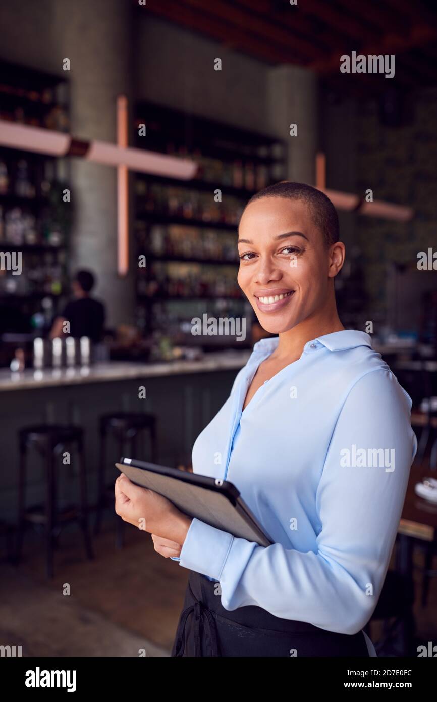 Portrait Of Confident Female Owner Of Restaurant Bar Standing By ...
