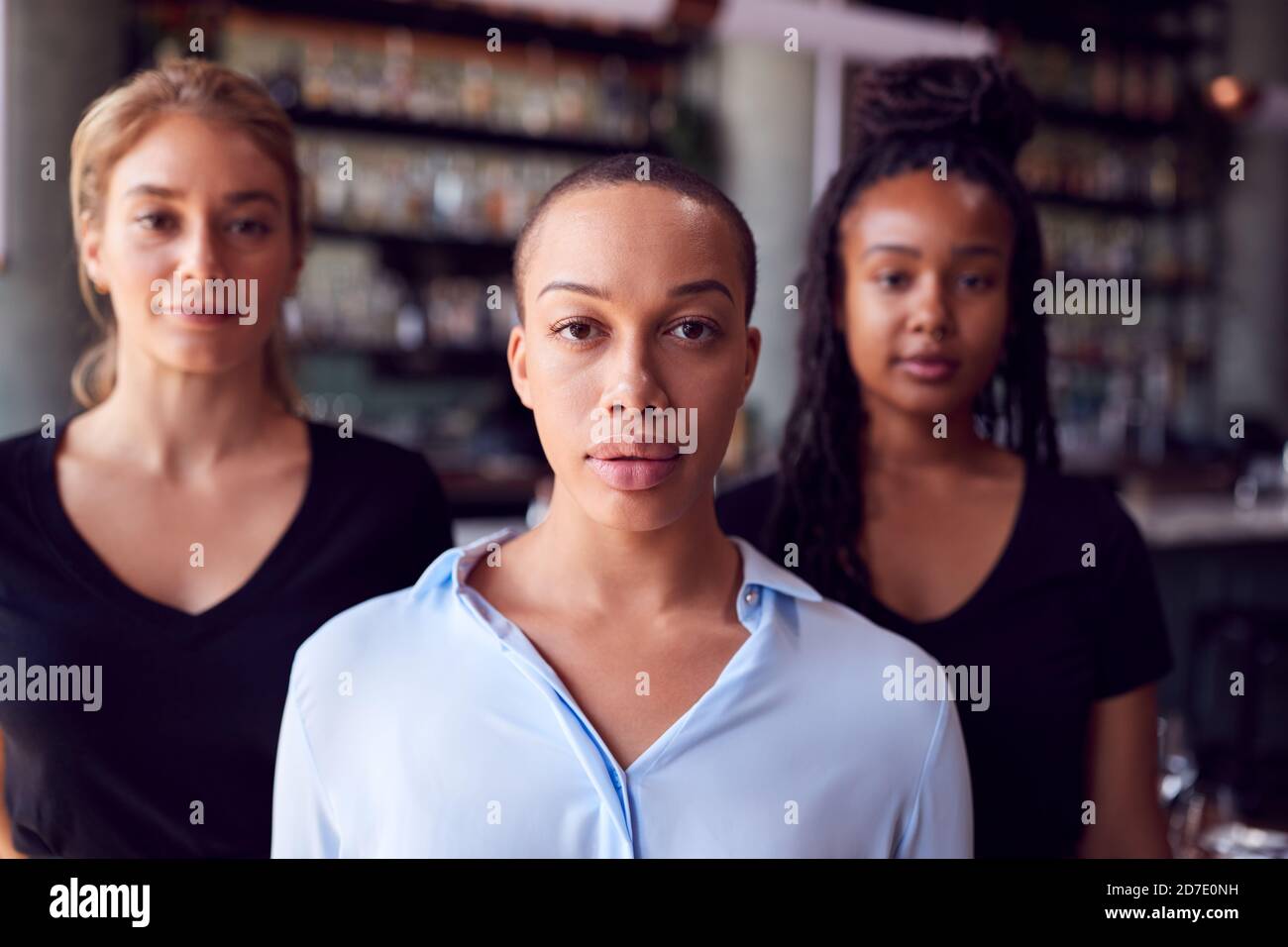 Portrait Of Female Owner Of Restaurant Bar With Team Of Waiting Staff ...