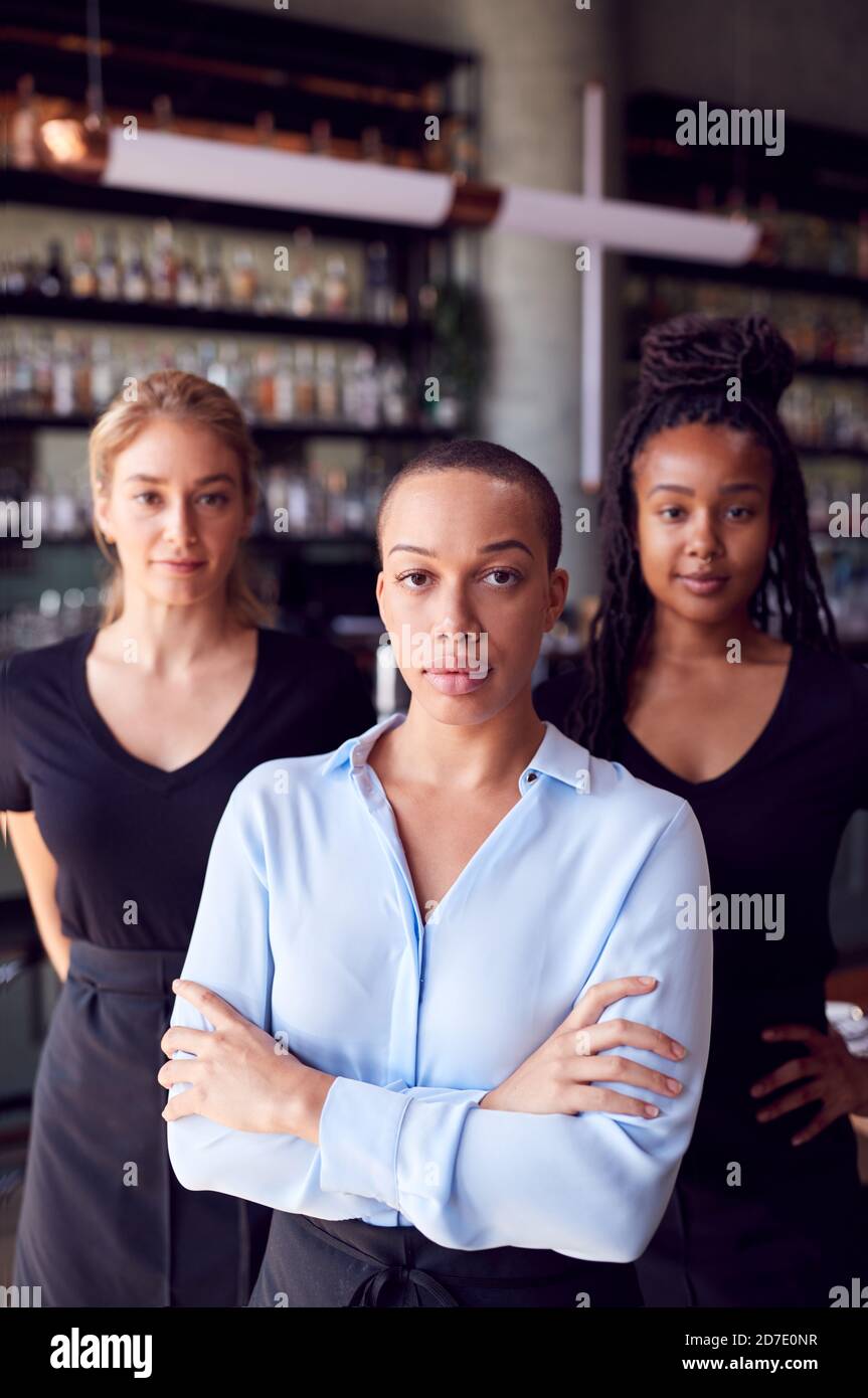 Portrait Of Female Owner Of Restaurant Bar With Team Of Waiting Staff ...