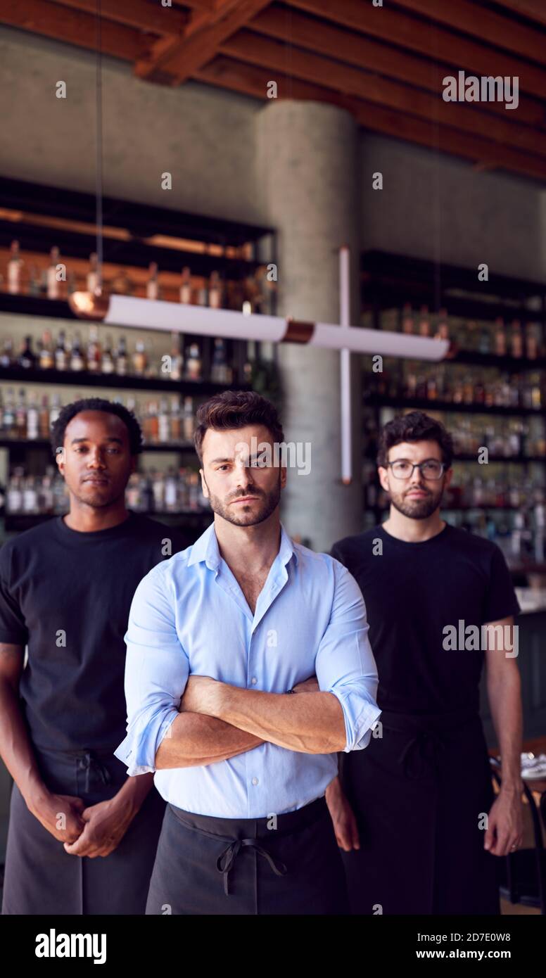 Portrait Of Male Owner Of Restaurant Bar With Team Of Waiting Staff ...