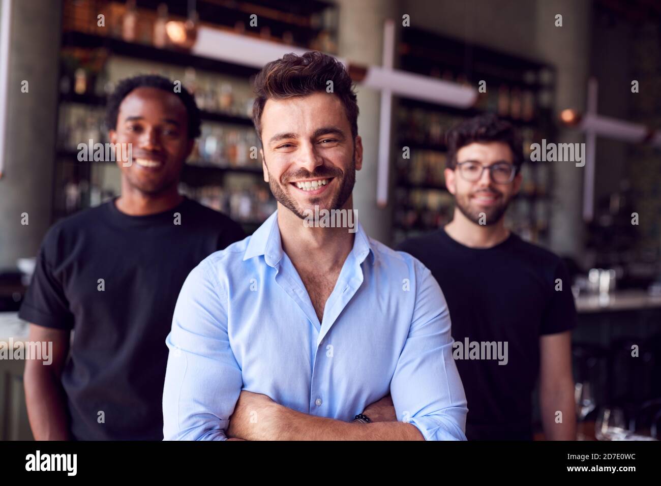 Portrait Of Male Owner Of Restaurant Bar With Team Of Waiting Staff ...