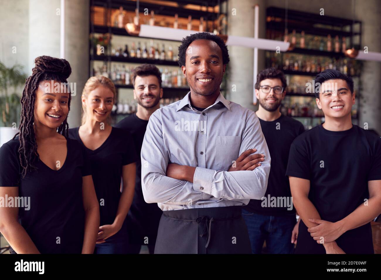 Portrait Of Male Owner Of Restaurant Bar With Team Of Waiting Staff ...