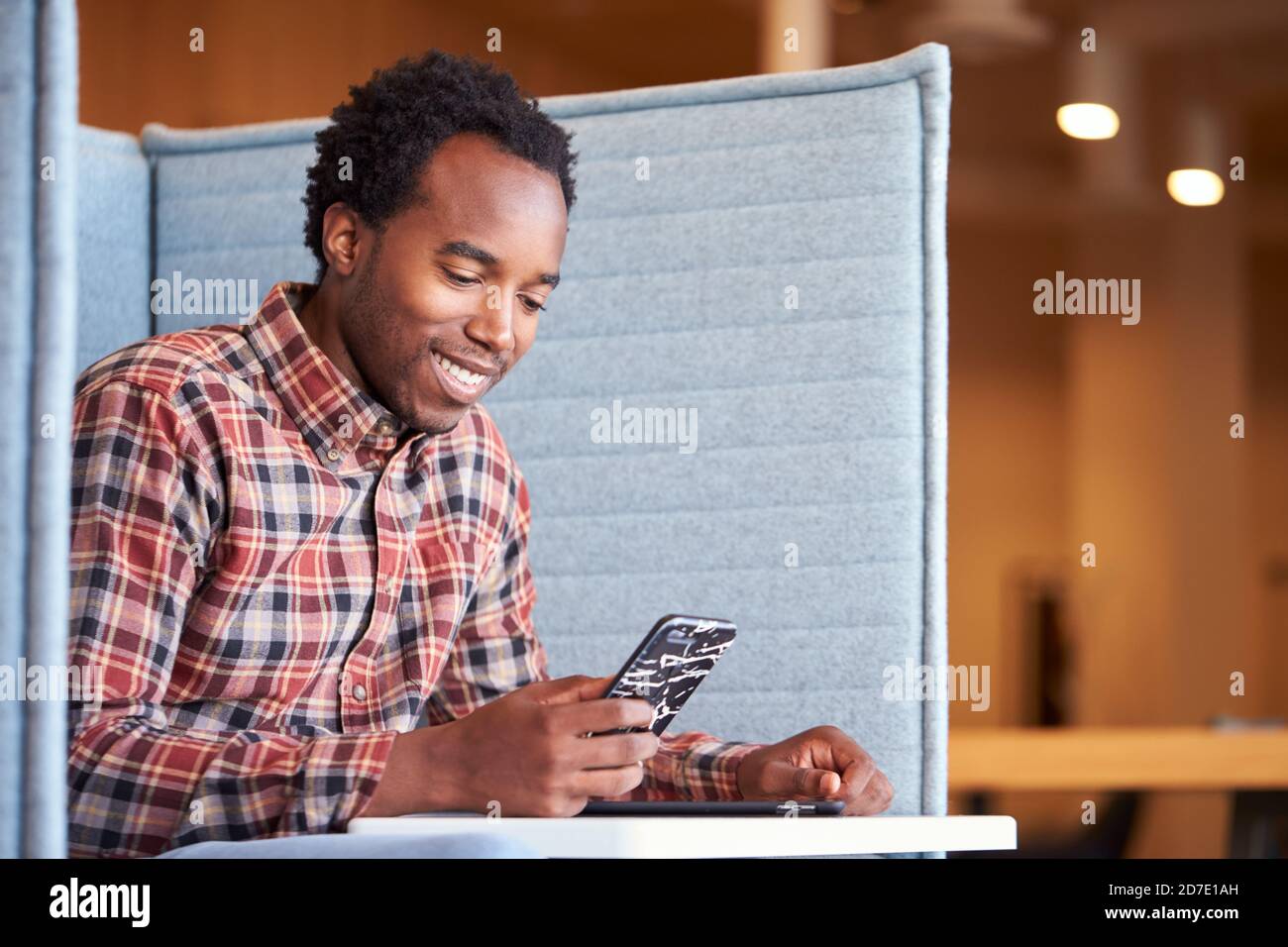 Businessman At Desk In Cubicle In Modern Office Work Space Using Mobile ...