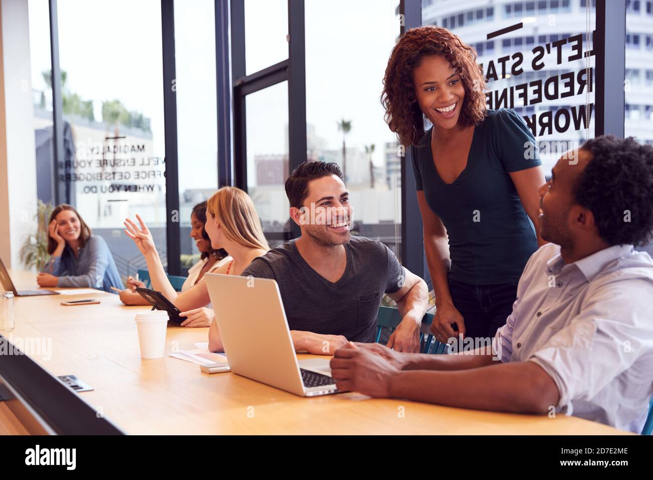 Businessmen And Businesswomen Working In Shared Open Plan Office ...