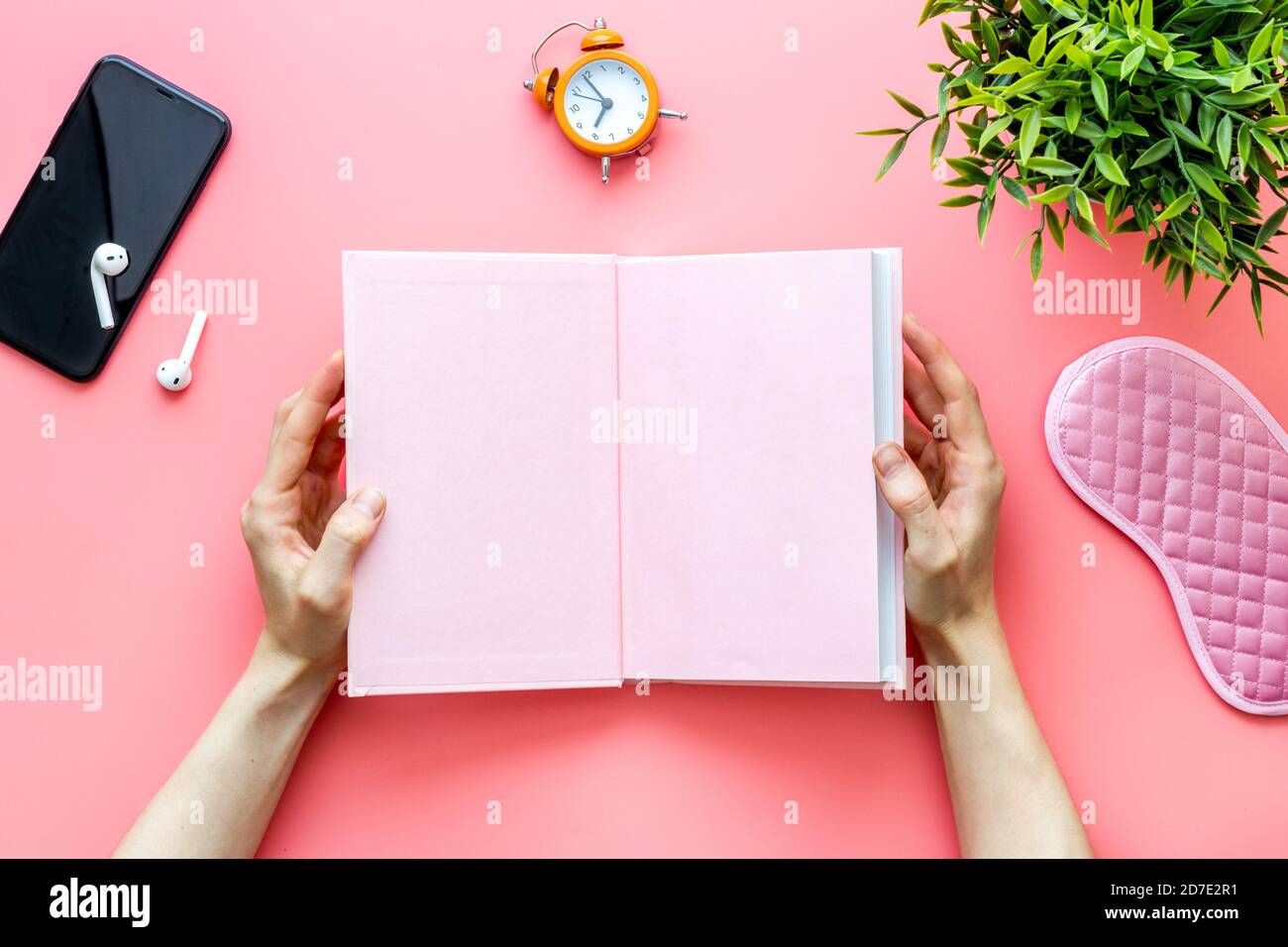 Reading book before going to bed. Sleeping accessories on the table ...