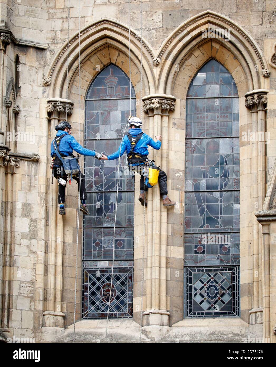 Workers from Heritage Stone Access abseil from the roof of York Minster ...