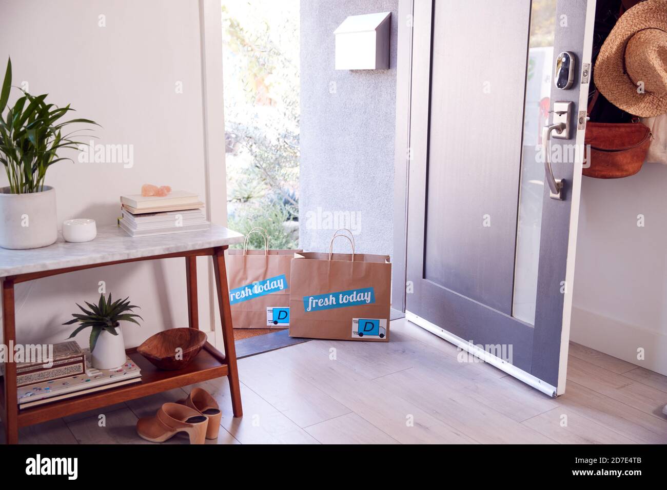 Open Front Door Of House With Home Delivery Food Bags Stock Photo - Alamy