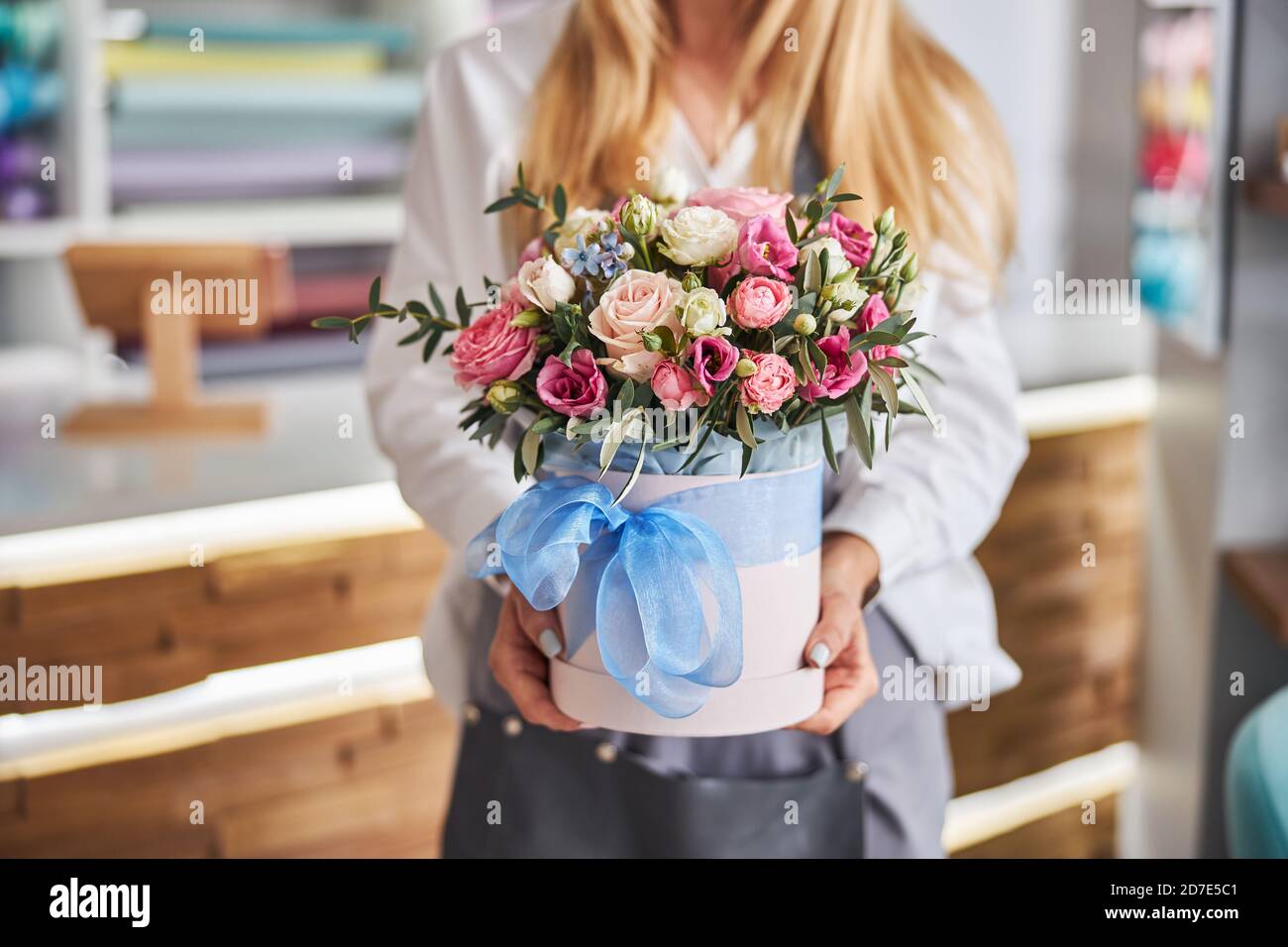 Beautiful female florist holding a gorgeous bouquet Stock Photo - Alamy