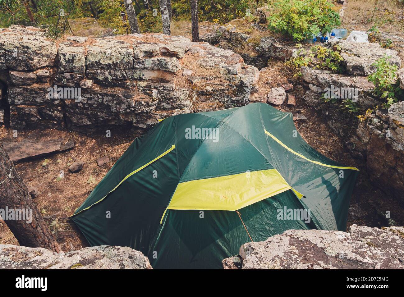 Tourist tent in forest camp among meadow Stock Photo - Alamy