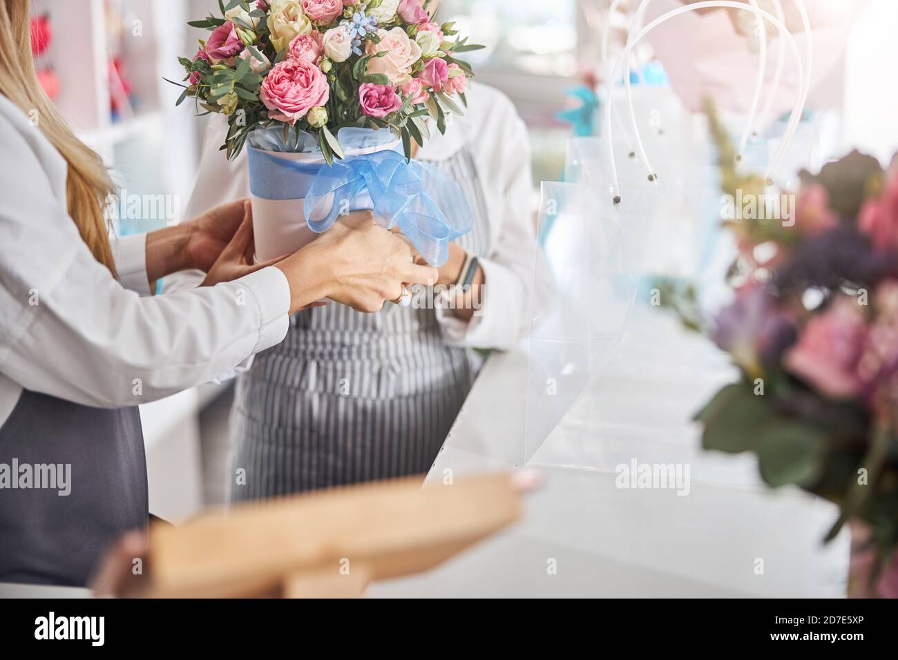 Two professional flower shop workers getting a bouquet ready Stock ...