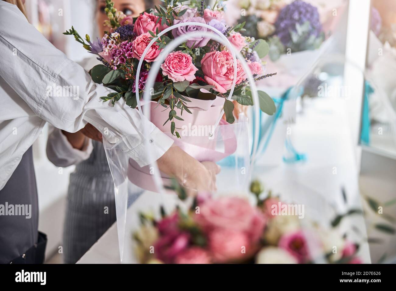 Pretty flower compositions being prepared by flower shop staff Stock ...