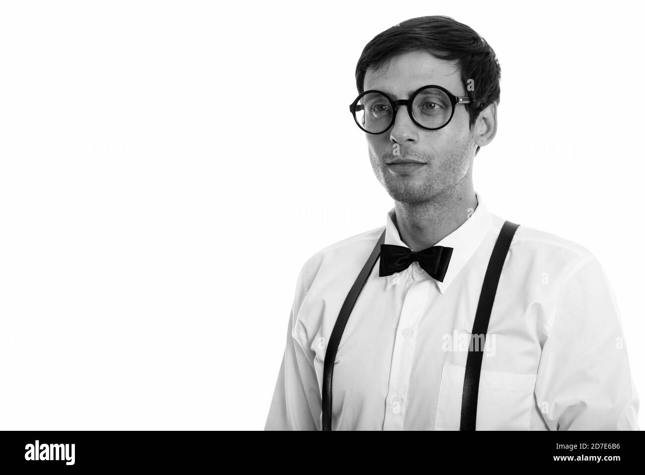 Studio shot of young handsome man thinking while wearing suspenders and ...