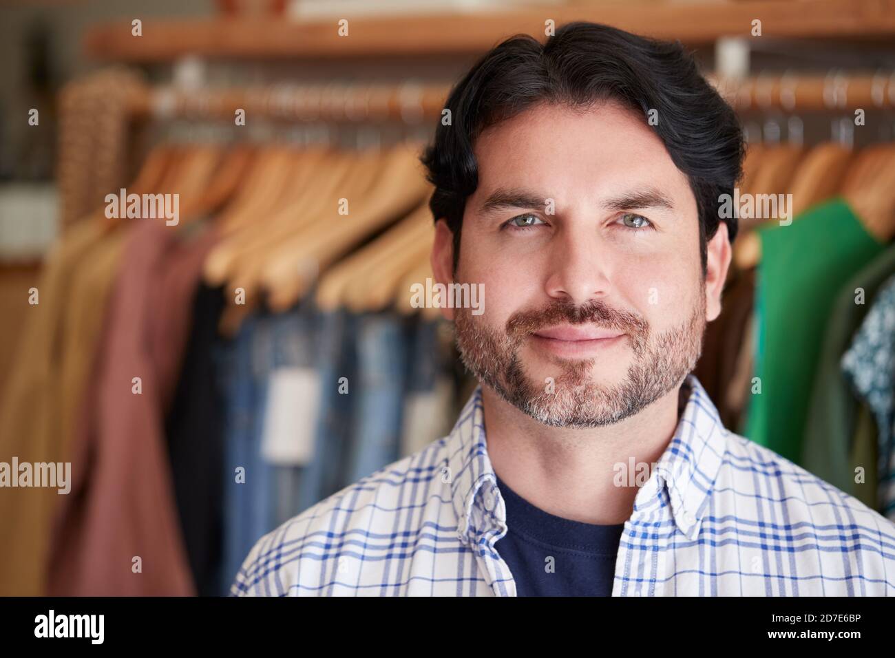 Portrait Of Male Owner Of Fashion Store Standing In Front Of Clothing ...