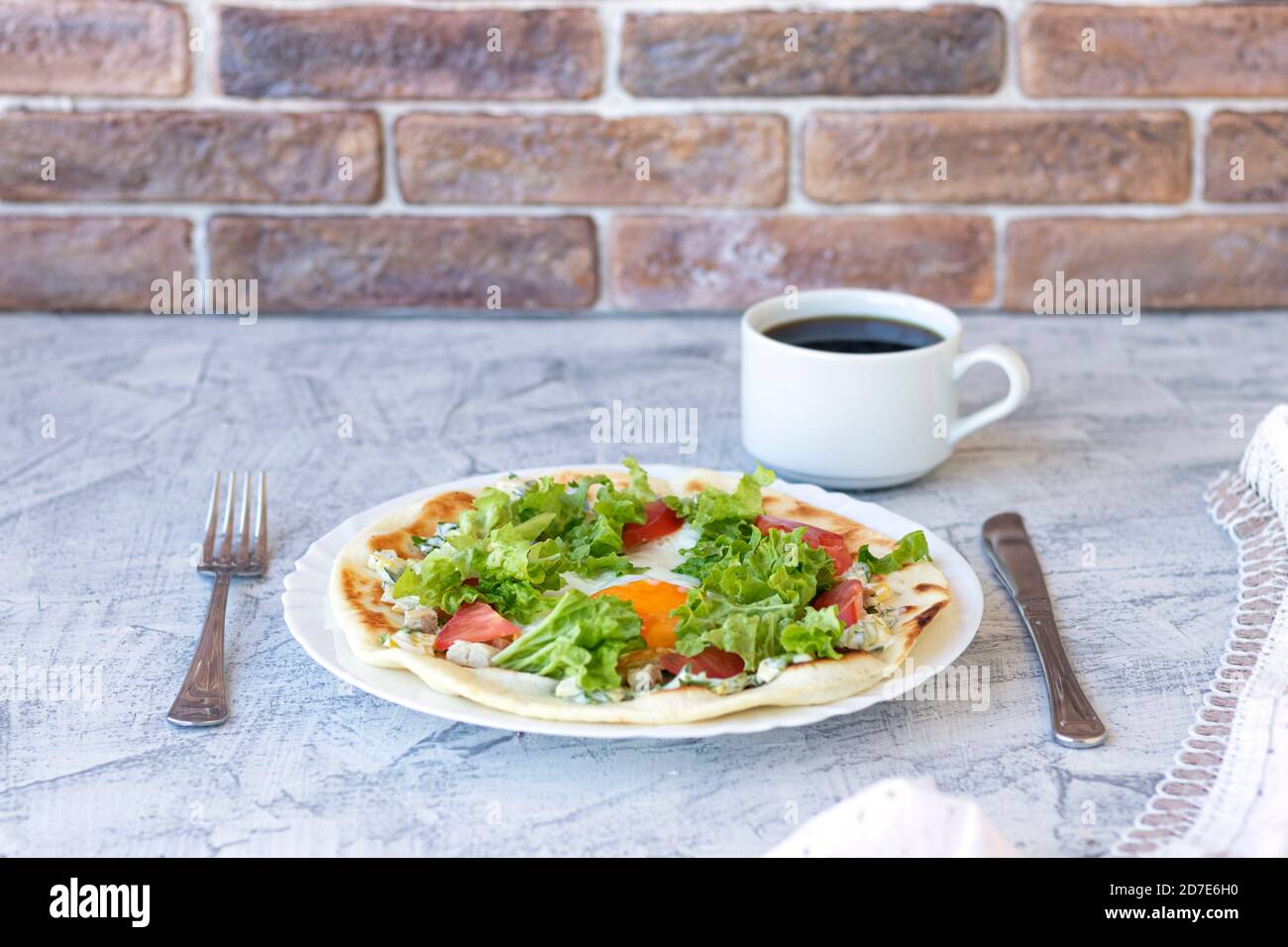 Italian breakfast with coffee. Piadina with egg, tomatoes and salad ...
