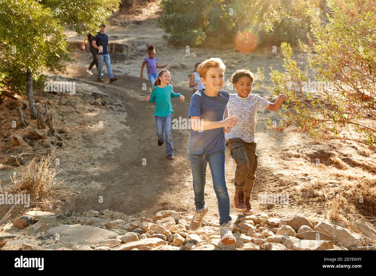 Adult Team Leaders With Group Of Children At Outdoor Activity Camp ...
