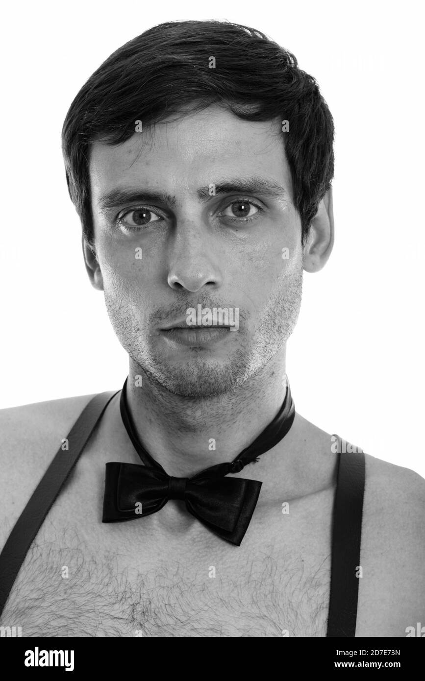 Face of young handsome man wearing suspenders and bow tie shirtless ...