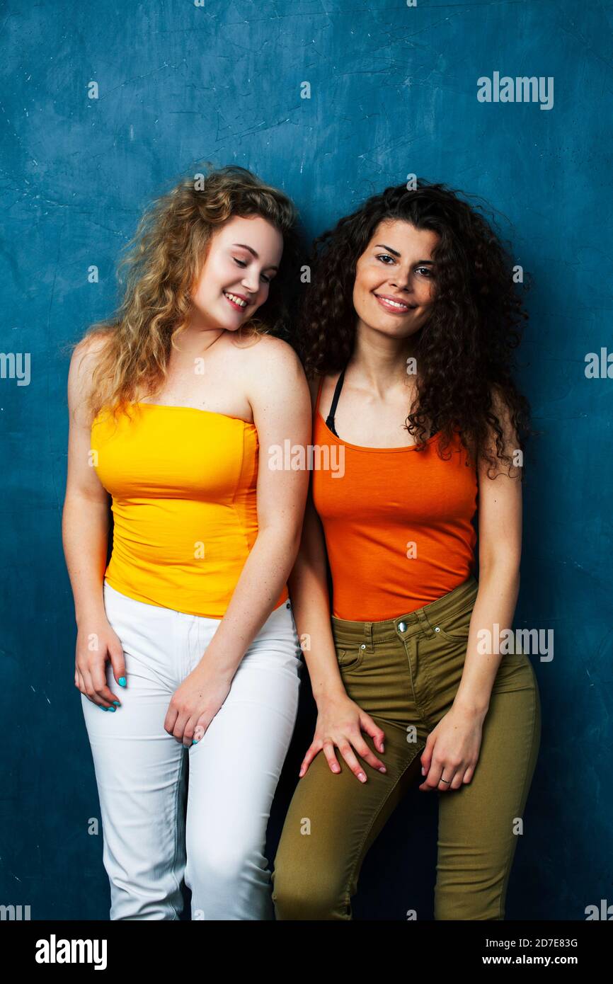 young pretty teenage girls friends with blond and brunette curly hair ...