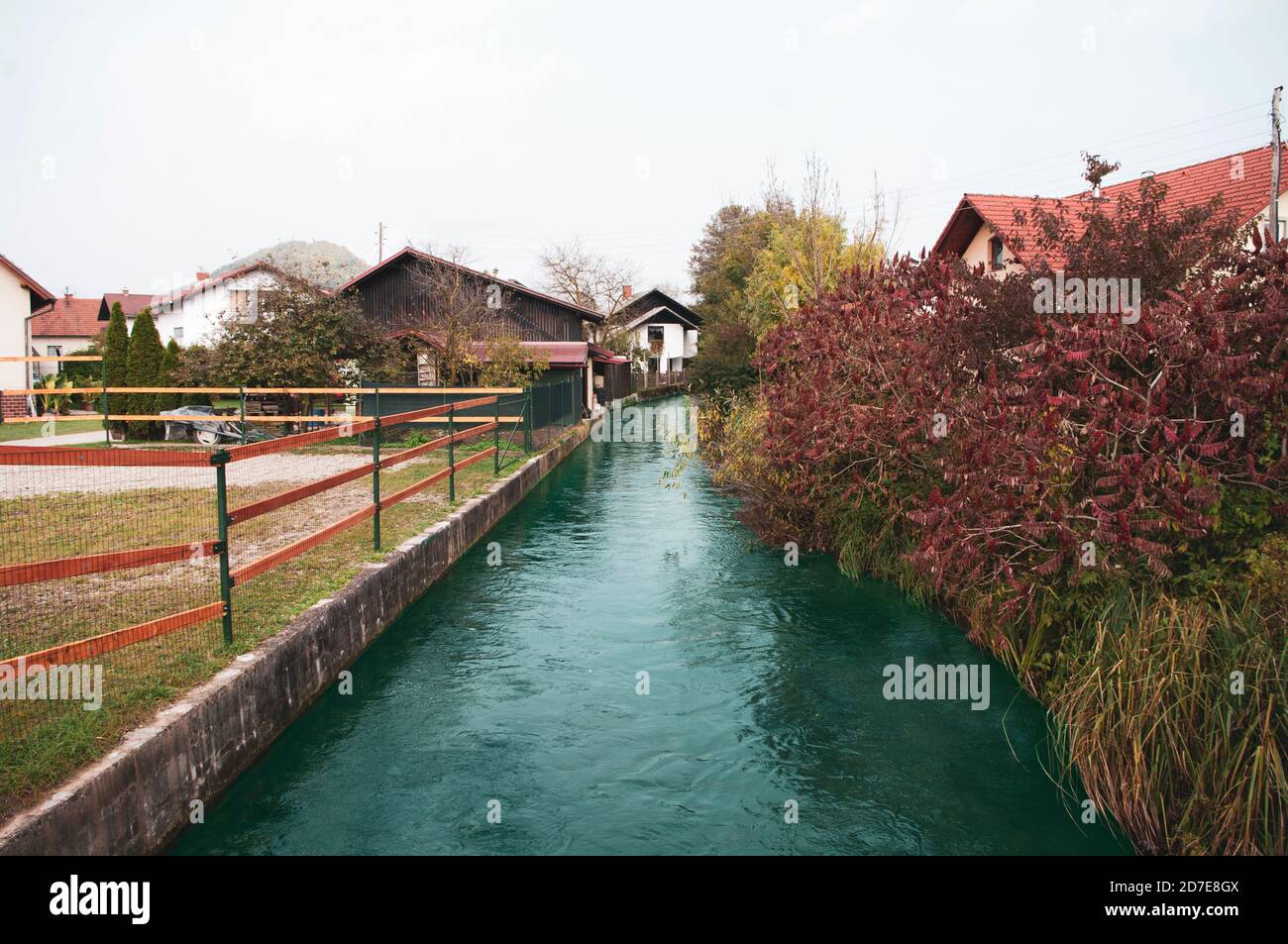 Small river goes in village between houses, autumn season Stock Photo ...