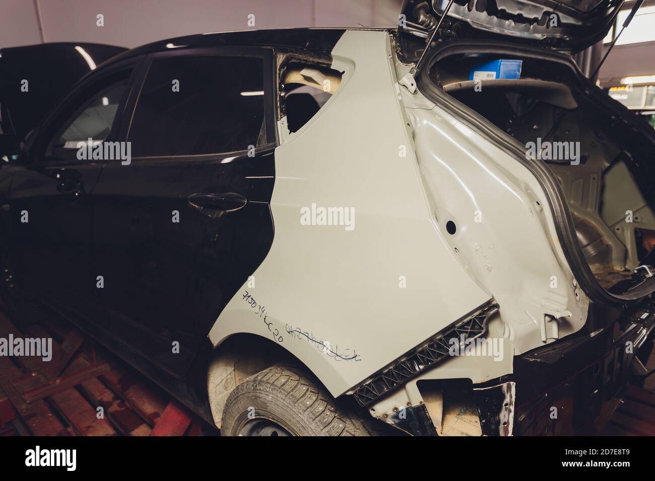 professional repairman worker in automotive industry welding metal body ...