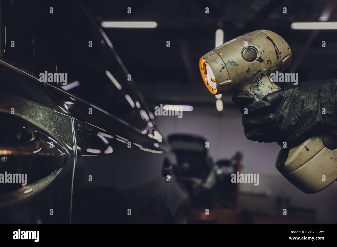 colourist man compare color sample with car paint Stock Photo - Alamy