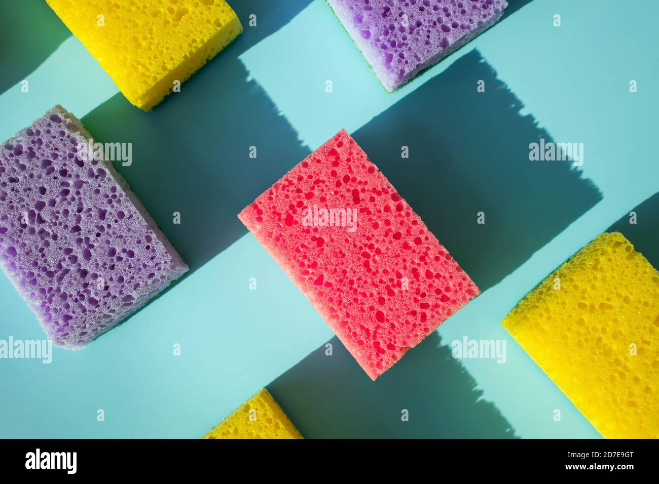 Cleaning sponges for washing dishes on blue background in natural light ...