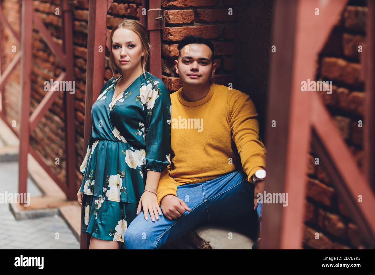 Young and trendy man and woman models walks on the street. in old town ...