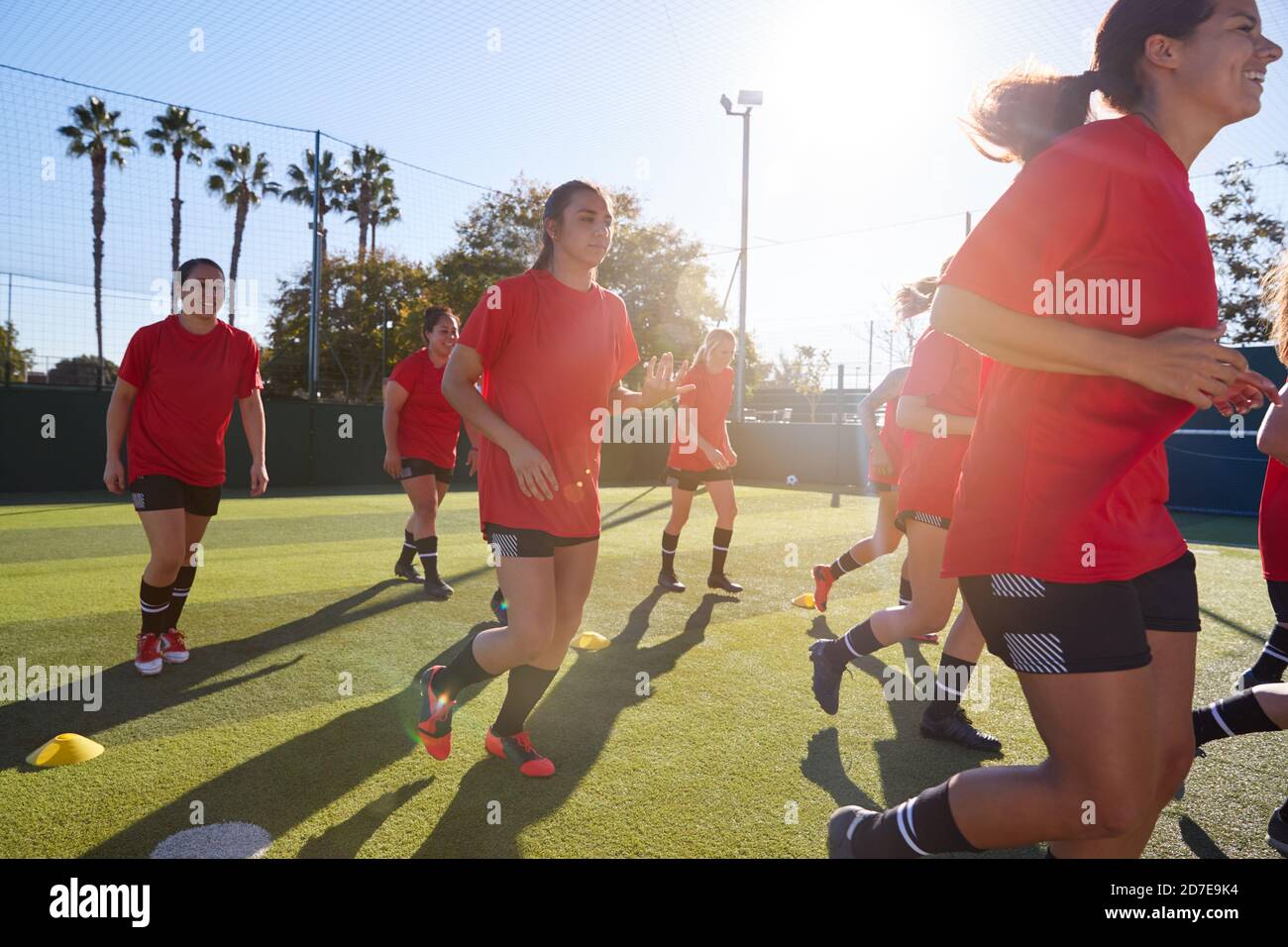 Womens Football Team Run Whilst Training For Soccer Match On Outdoor ...
